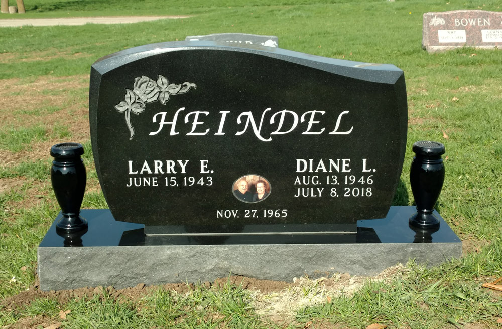 Two Grave Black Monument with curved top, carved flowers and vases ...